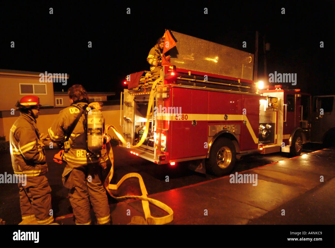 Volunteer firefighters practice fighting a school fire during a ...