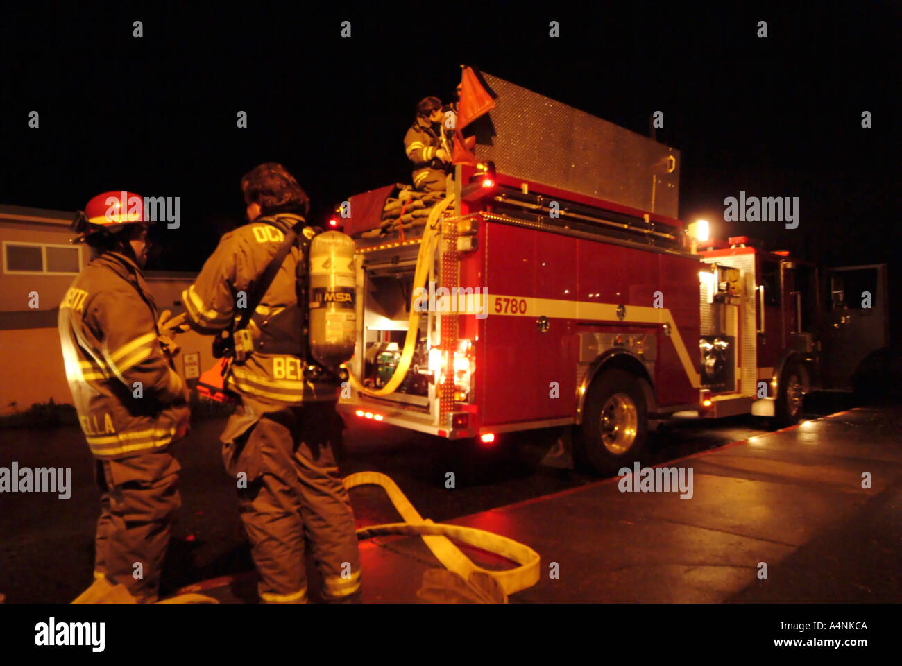 Volunteer firefighters practice fighting a school fire during a ...