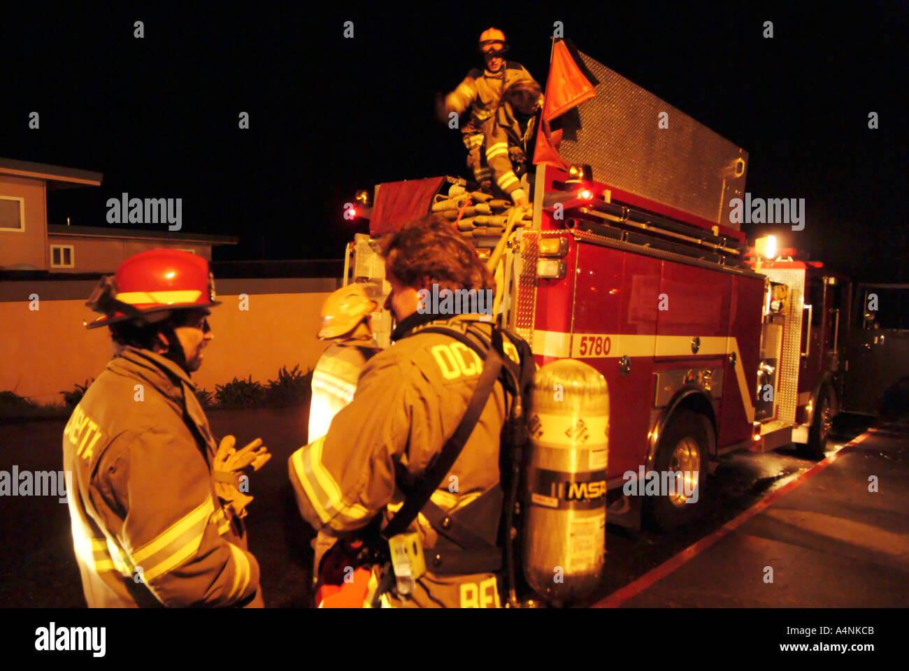 Volunteer firefighters practice fighting a school fire during a ...
