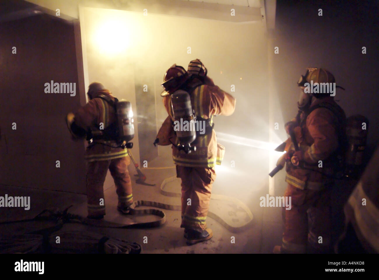 Volunteer firefighters practice fighting a school fire during a ...