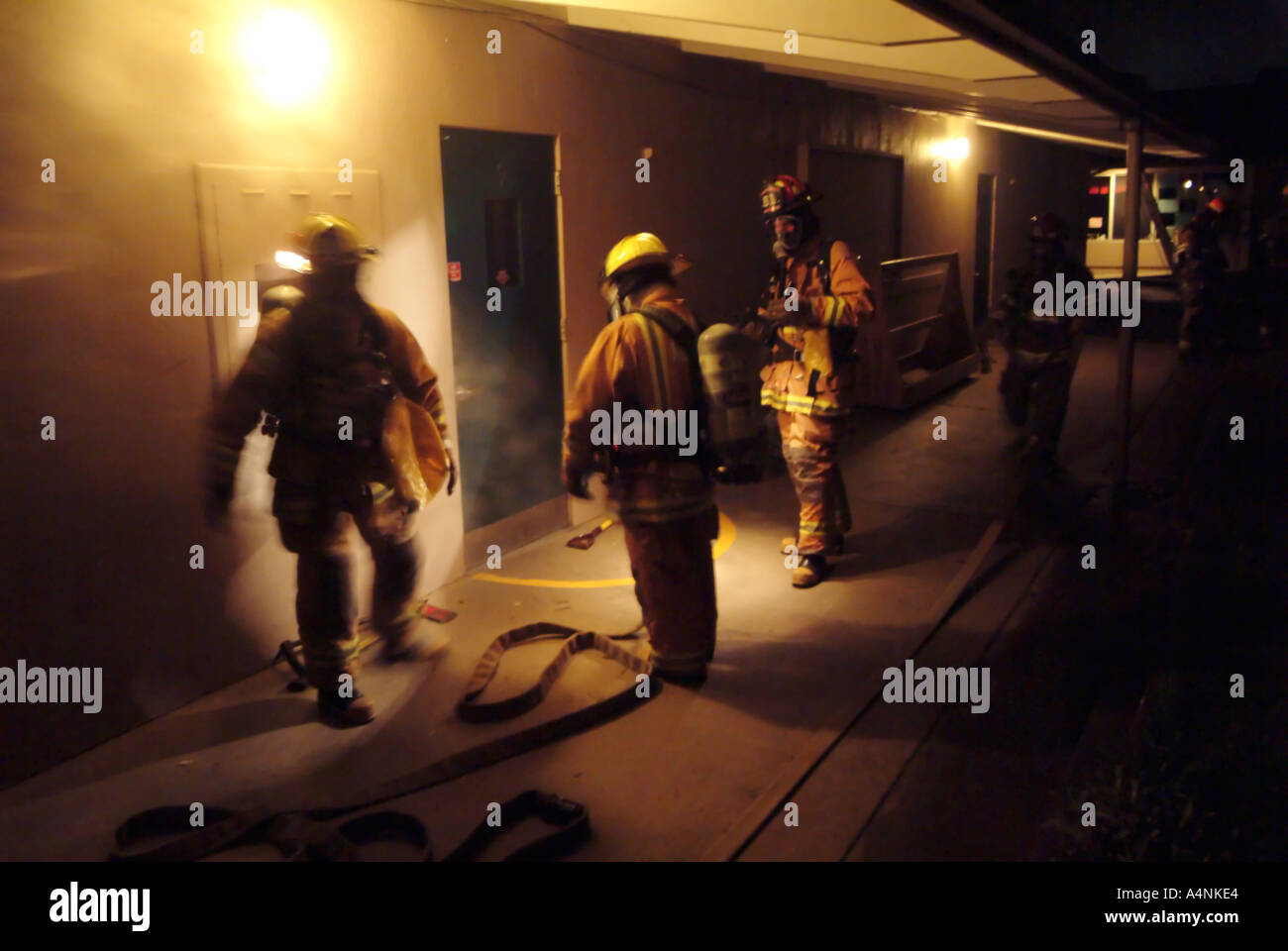 Volunteer firefighters practice fighting a school fire during a ...