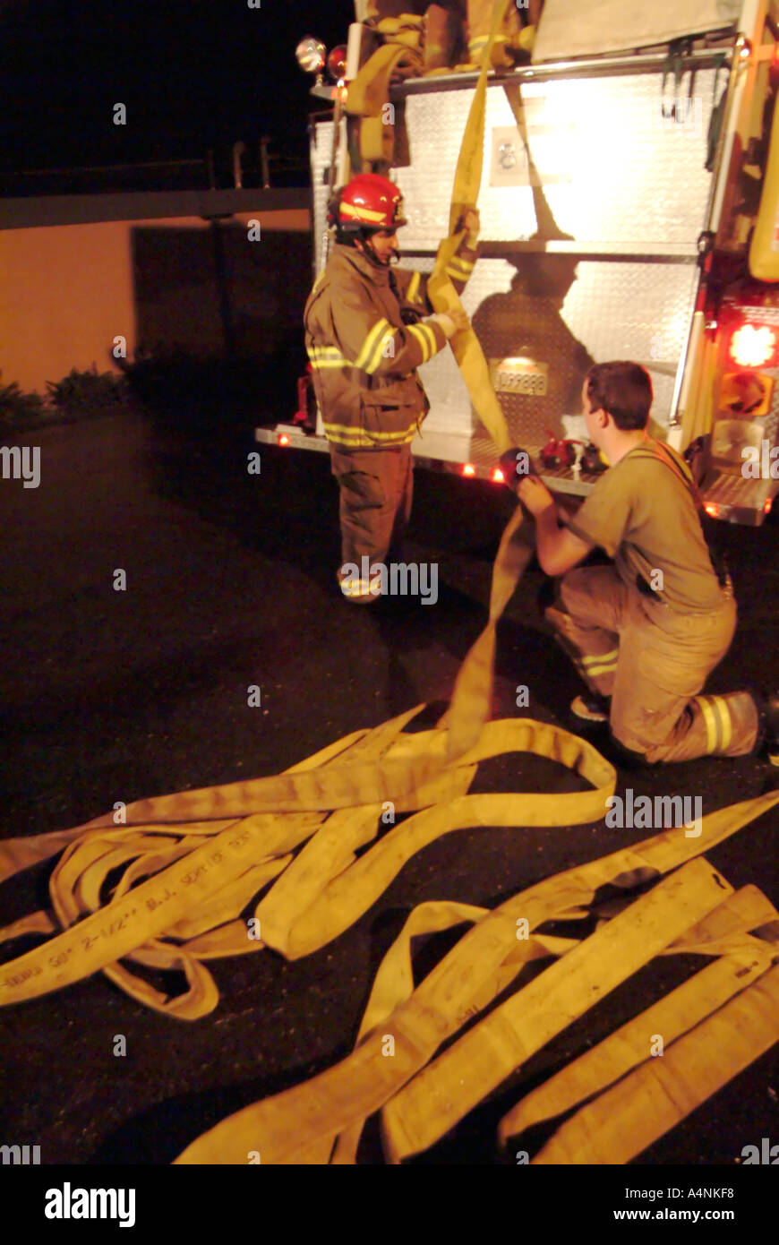Volunteer firefighters practice fighting a school fire during a ...