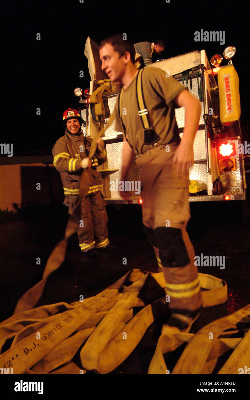 Volunteer firefighters practice fighting a school fire during a ...