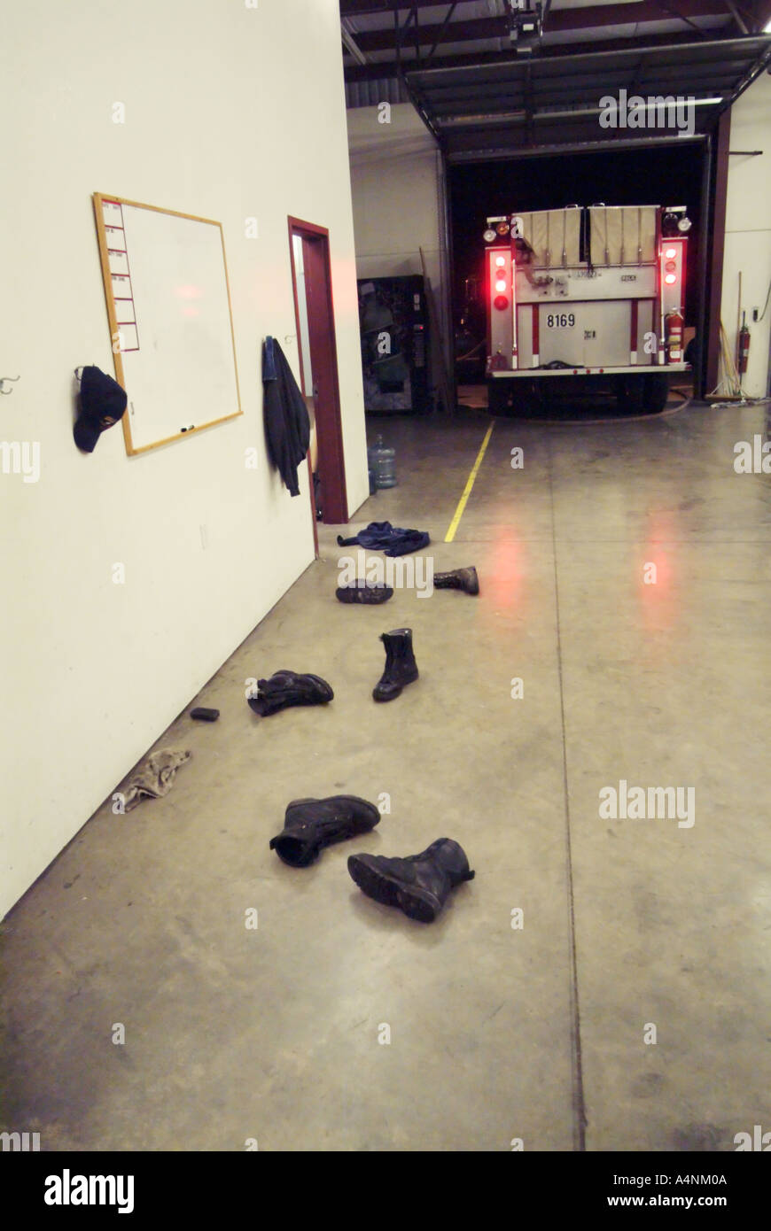 Firefighter trainees practice their skills dragging a hoseline while ...