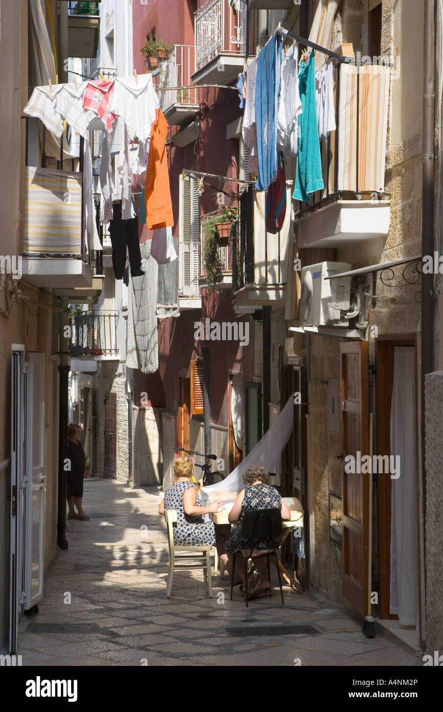 Women sitting and working in Bari Old Town Bari Italy Stock Photo - Alamy