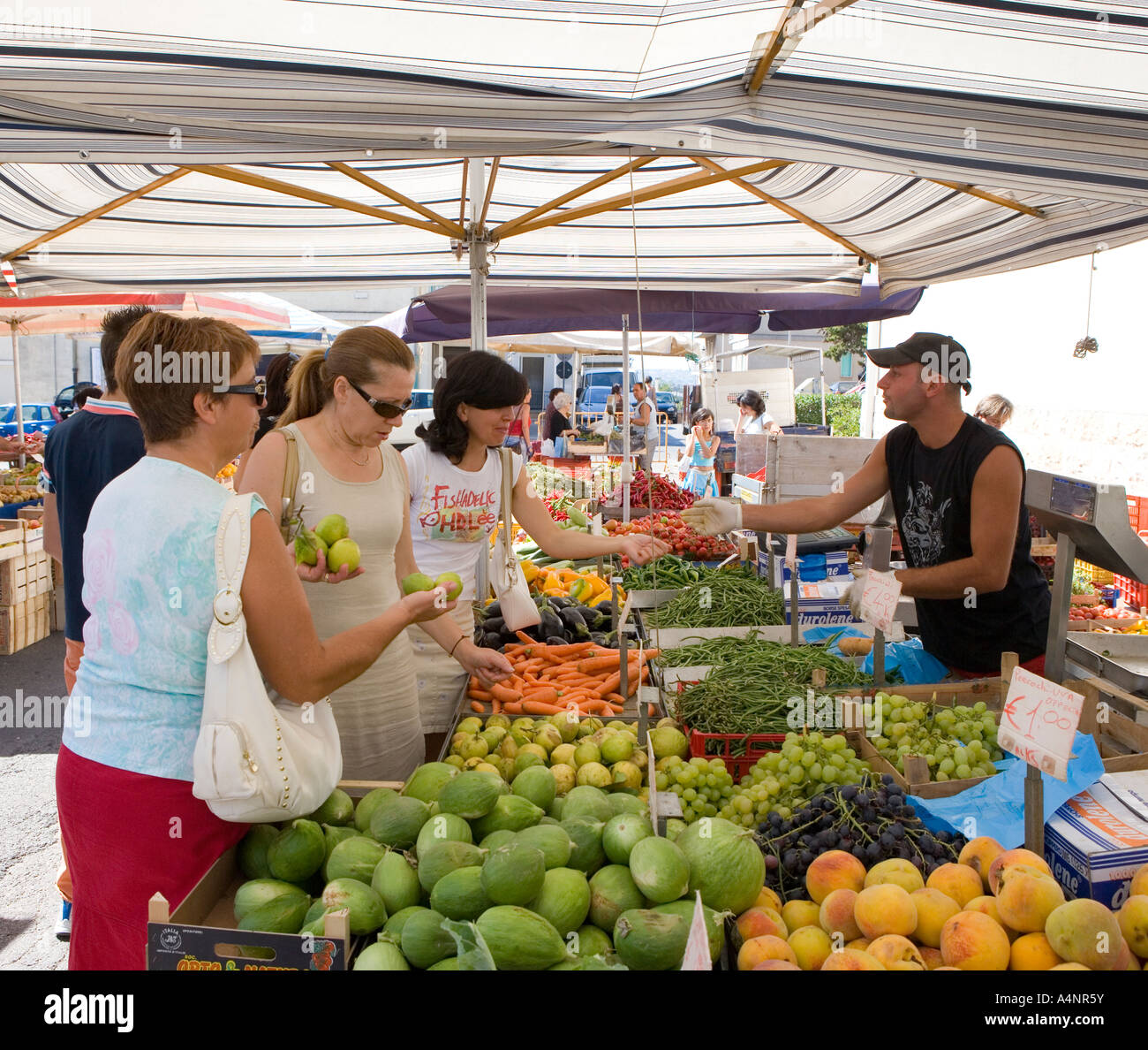 Buying vegetables and fruit Market day Cisternino Puglia Italy Stock ...