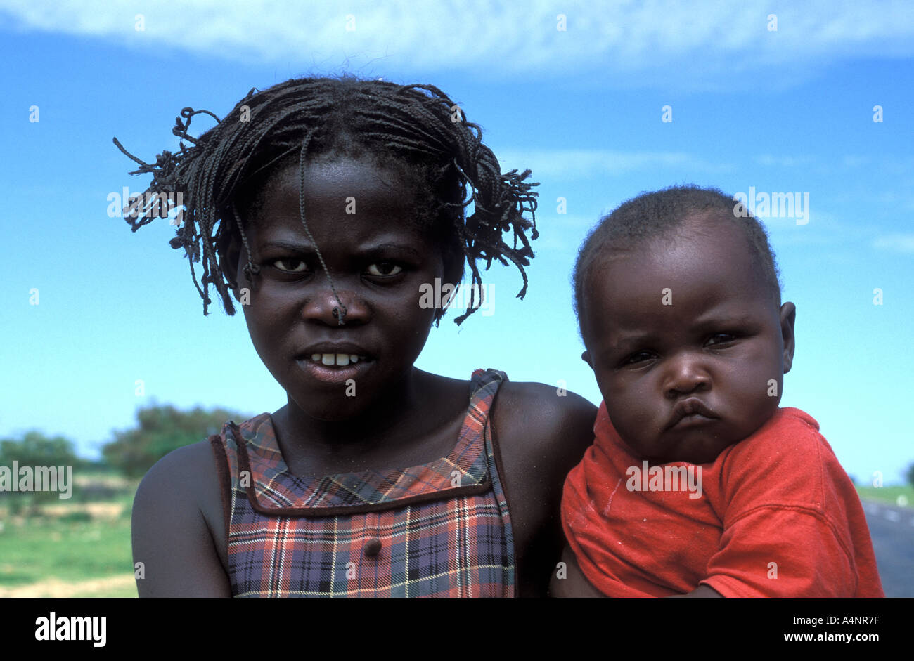Girl of Ovambo tribe carrying toddler near Kamajab Ovamboland Namibia ...