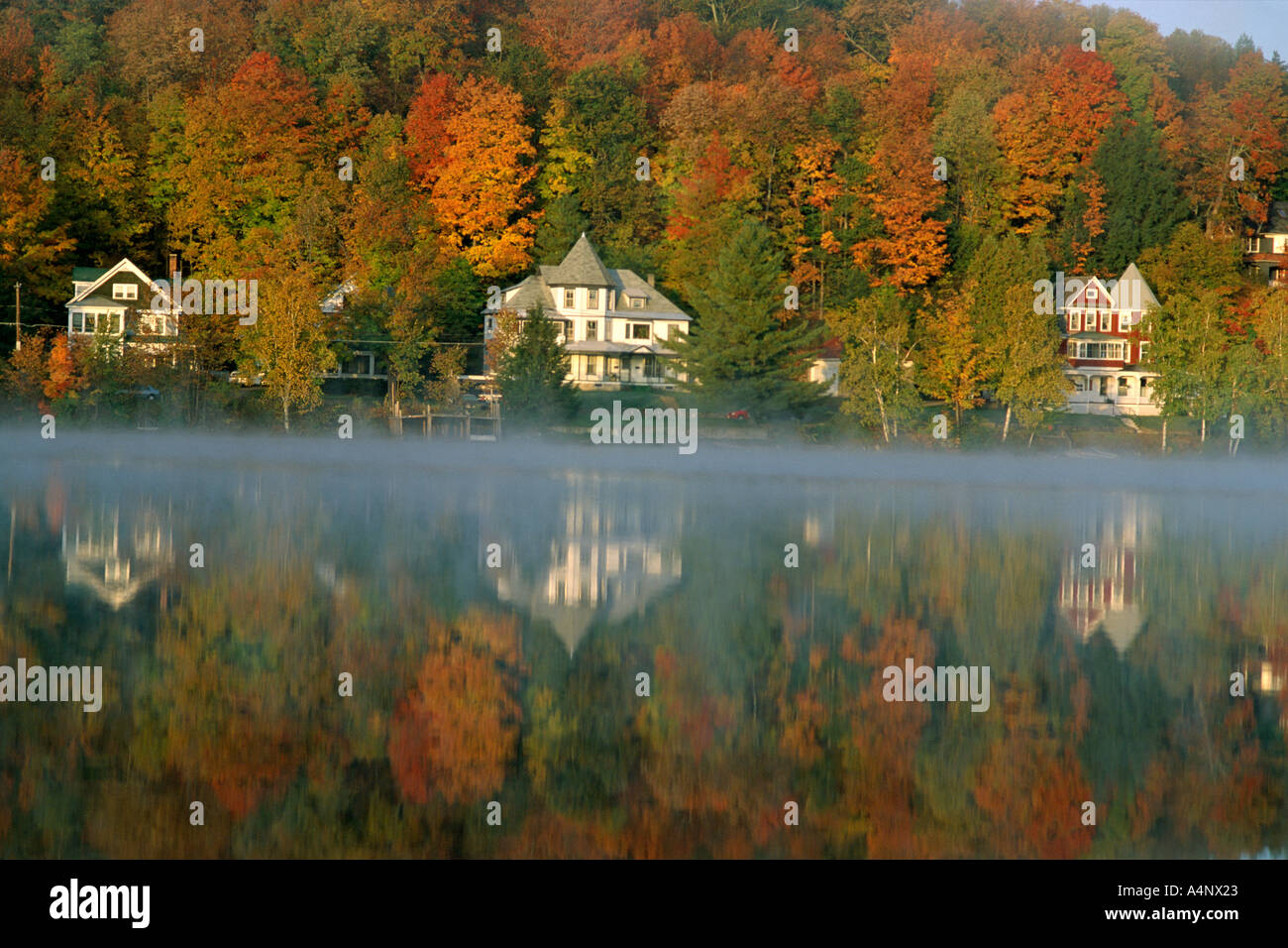 Large houses beside Lake Flower at Saranac Lake Town in early morning ...