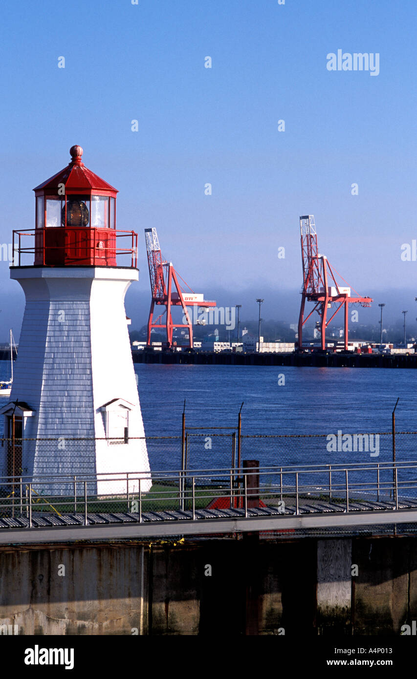 Lighthouse and heavy cranes used for off loading container ships at the ...