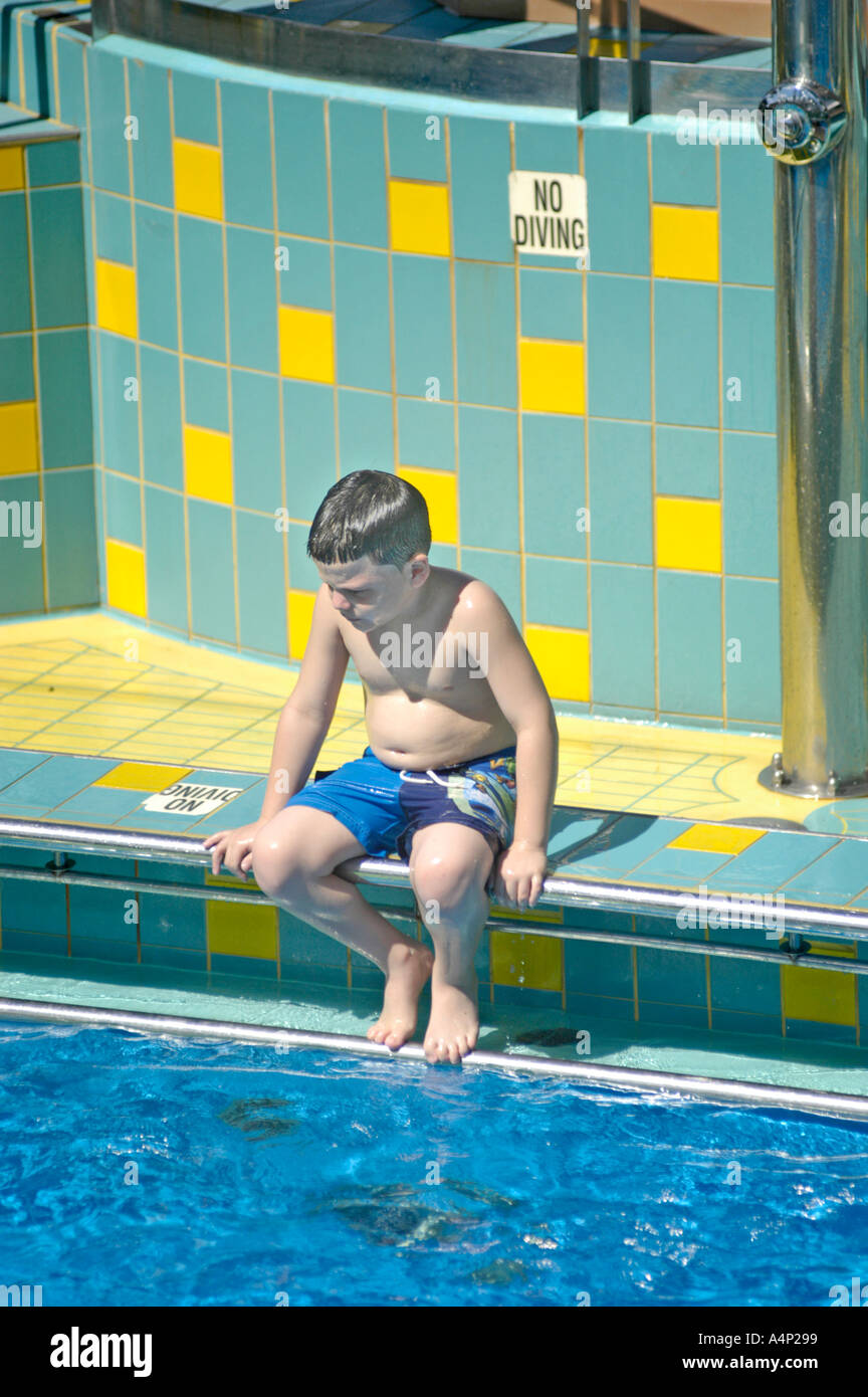 Young boy on the side of the pool on the Carnival Destiny looking at ...