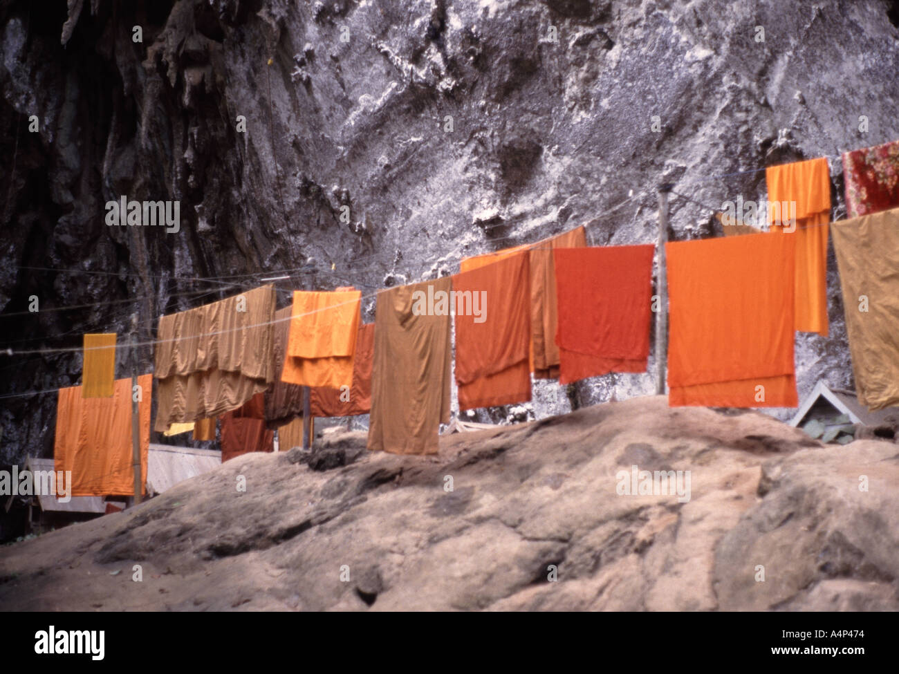 Buddhist monk s robes hang in a cave in Thailand Stock Photo - Alamy