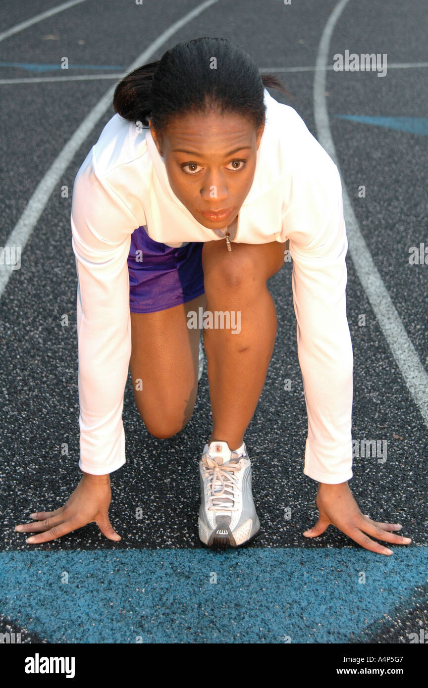 Black African-American woman at the starting line of a track and field ...