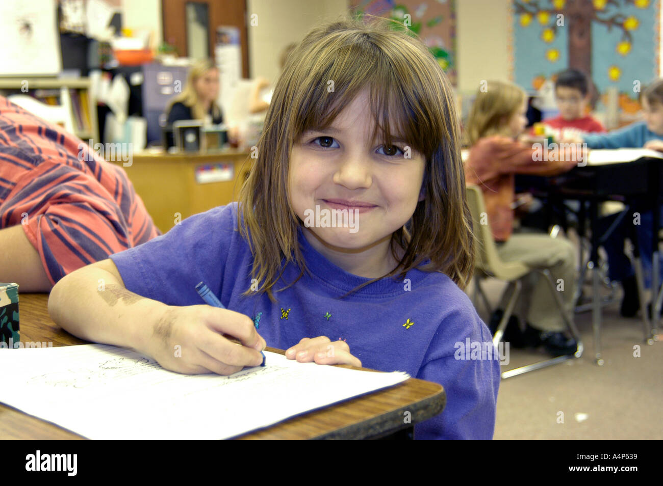 Grade 3 male and female students in a classroom learning situation ...
