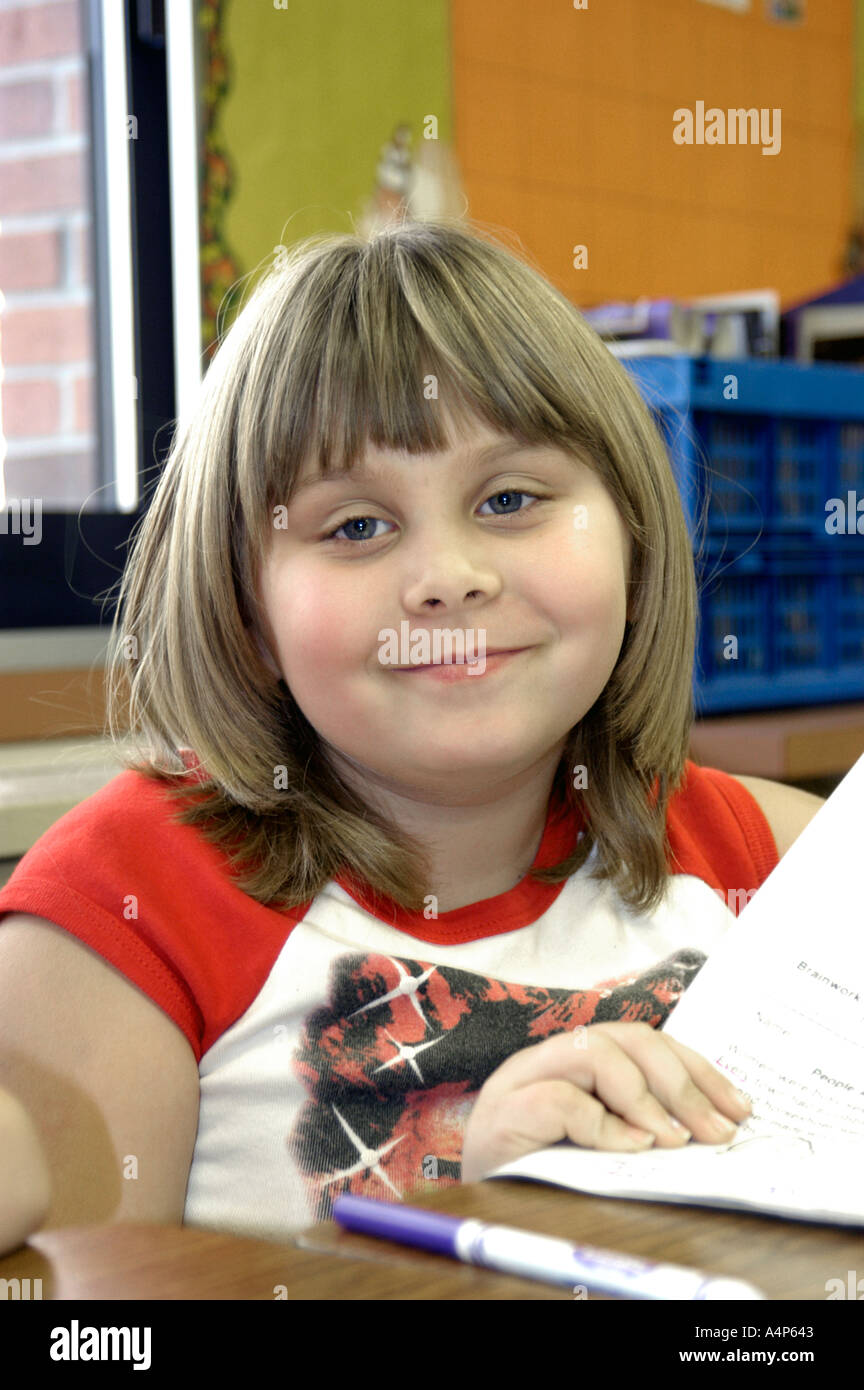 Grade 3 male and female students in a classroom learning situation ...