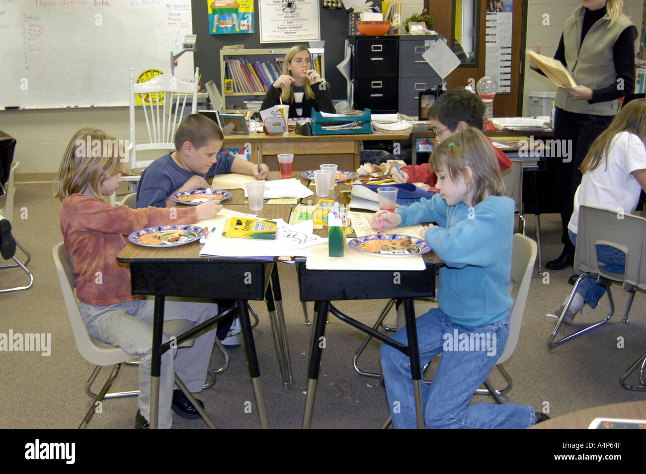 Grade 3 male and female students in a classroom learning situation ...