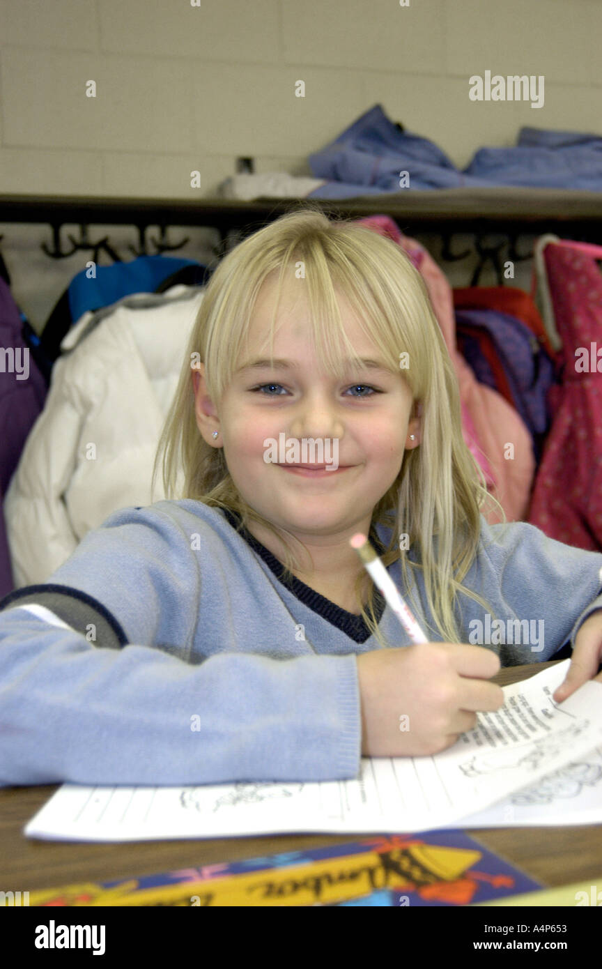 Grade 3 male and female students in a classroom learning situation ...