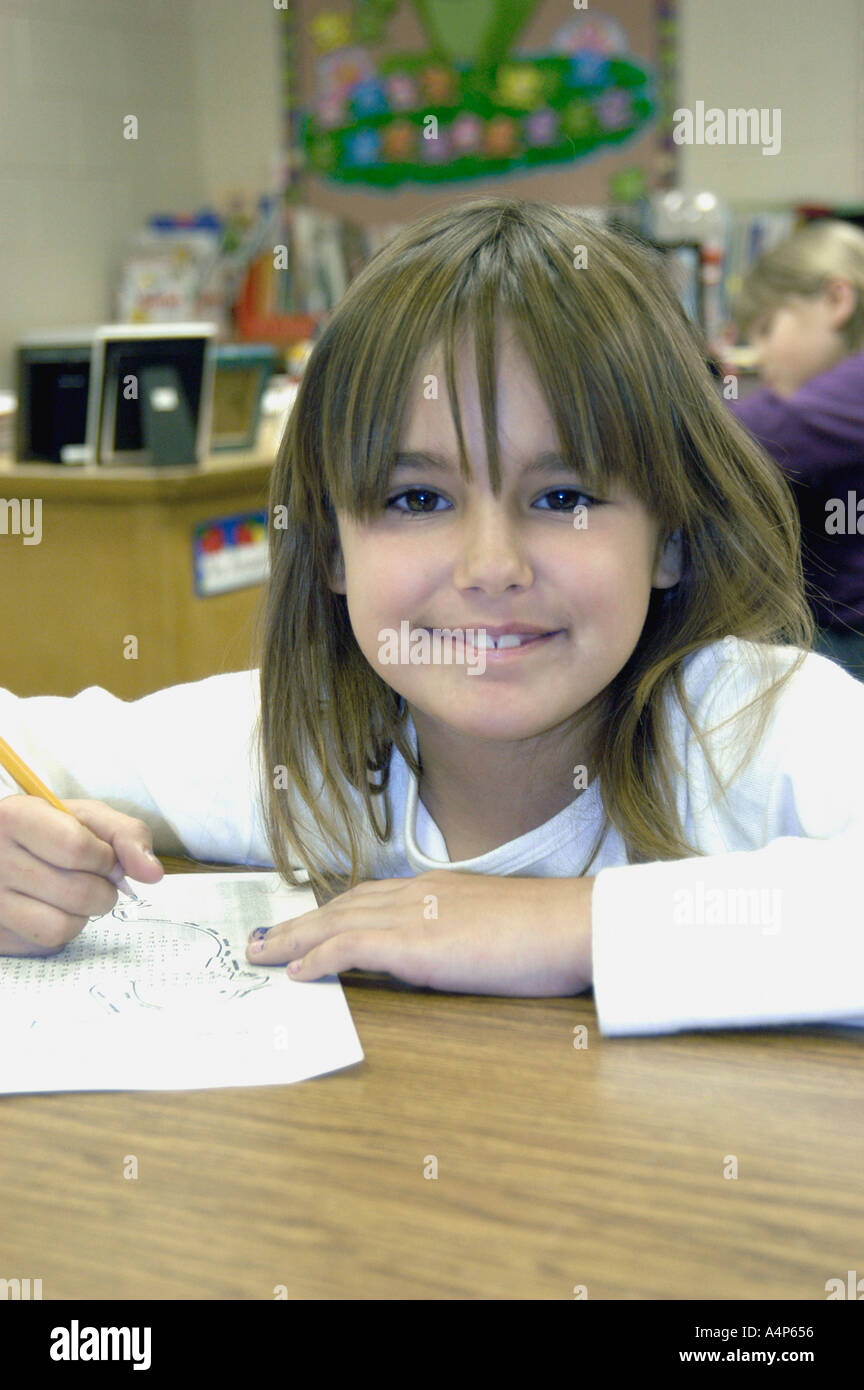 Grade 3 male and female students in a classroom learning situation ...