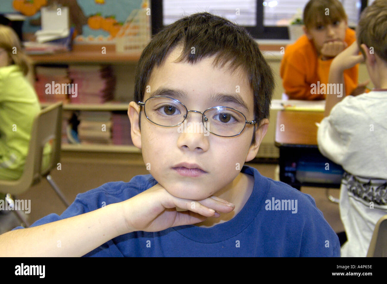 Grade 3 male and female students in a classroom learning situation ...