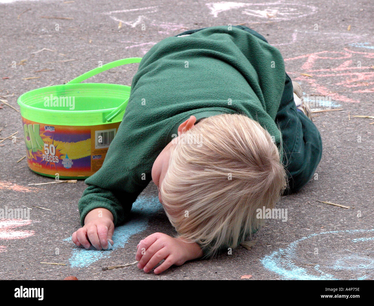 3 year old boy draws on sidewalk with chalk Stock Photo - Alamy