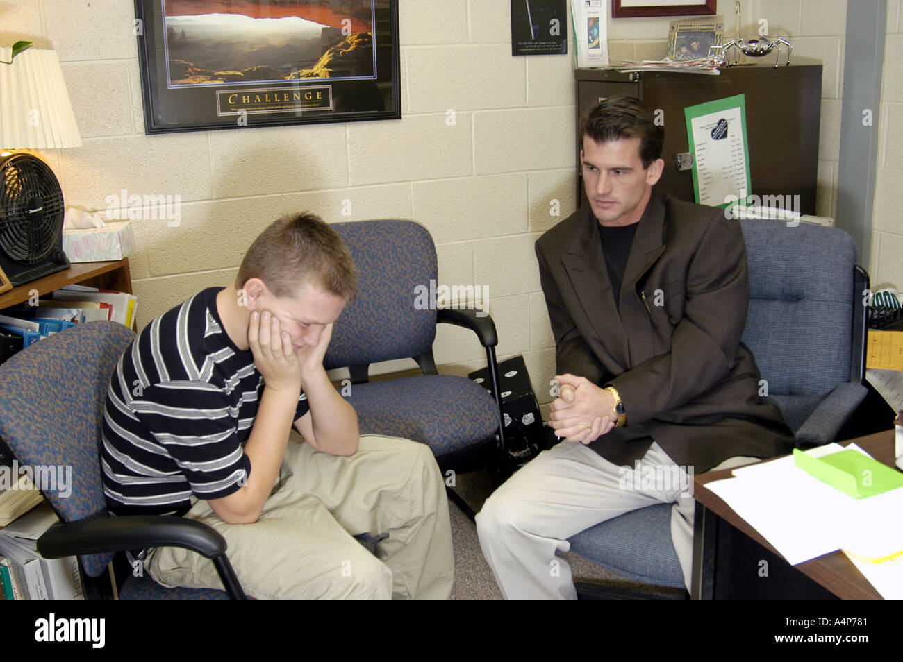 Counselor talks and advises male middle school age student Stock Photo ...