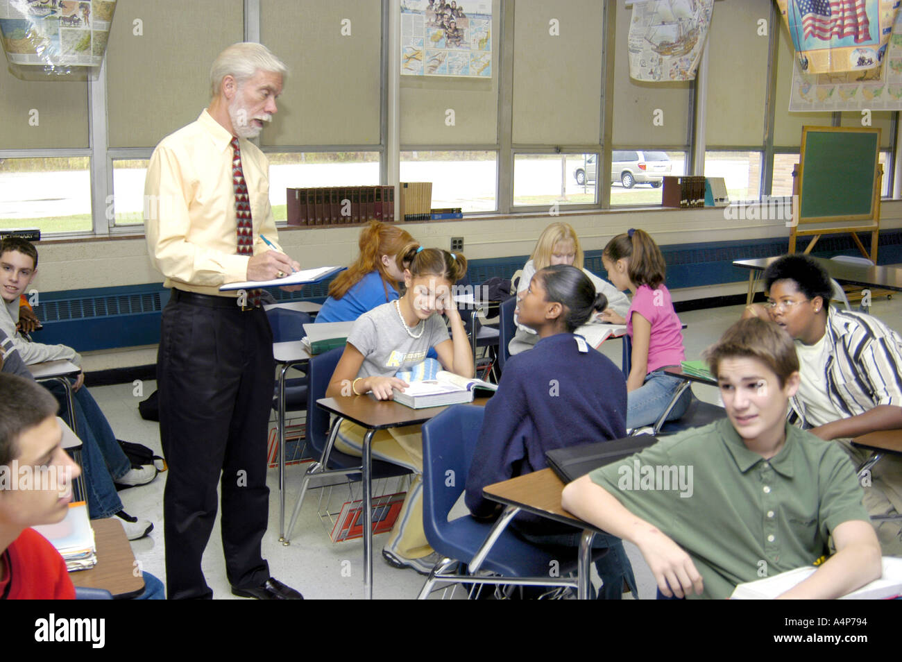Male middle school teachers works with students in class Stock Photo ...