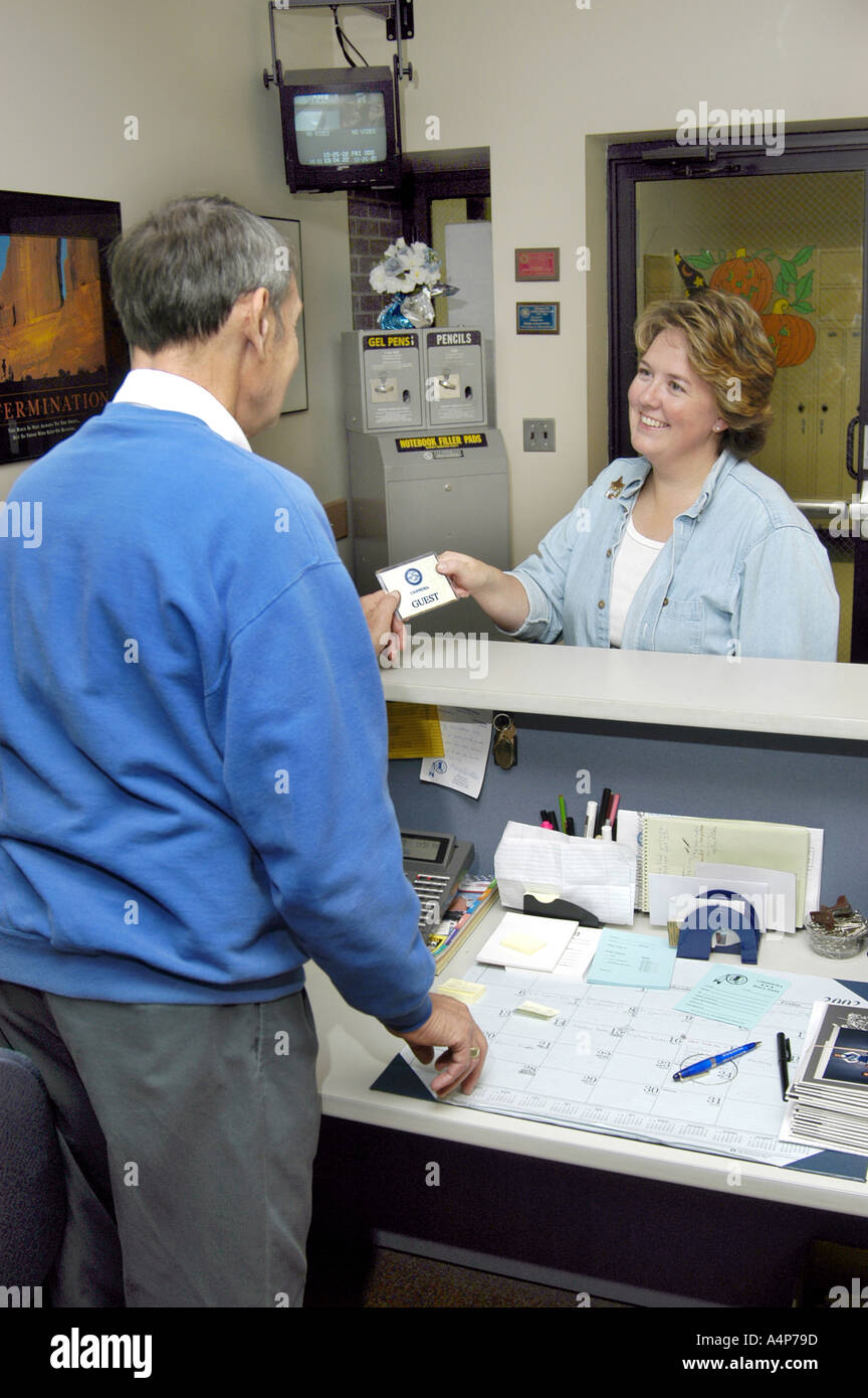 Middle school principal checks identification of female visiting school ...