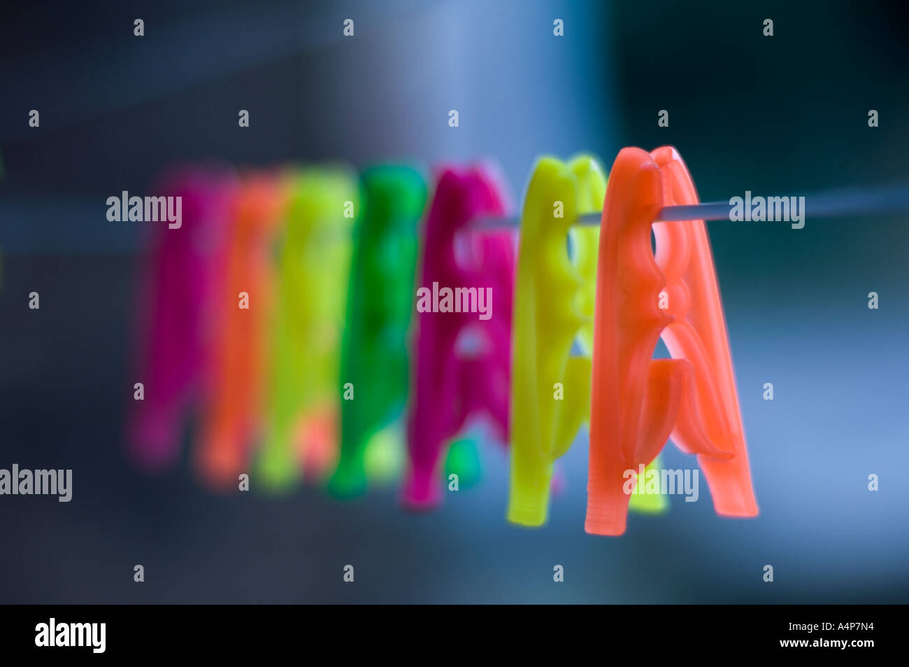 Multi Coloured Plastic pegs on a washing line Stock Photo - Alamy