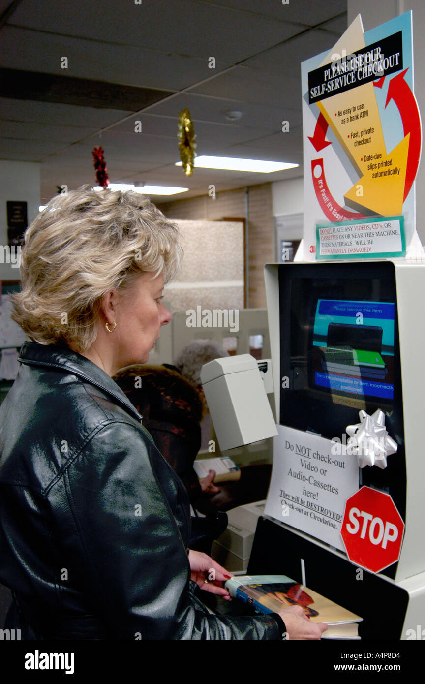Female uses self check out system at a public library Stock Photo - Alamy