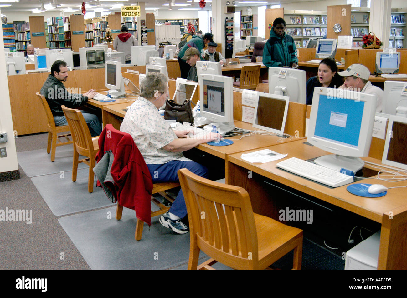 Adults surf the internet for free at a public library Stock Photo - Alamy
