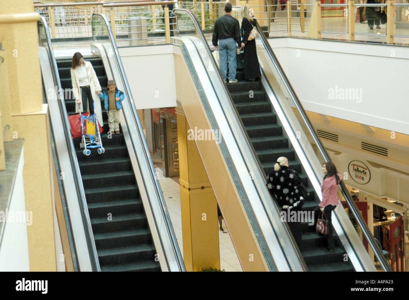 Escalators move shoppers in a large mall complex Stock Photo - Alamy