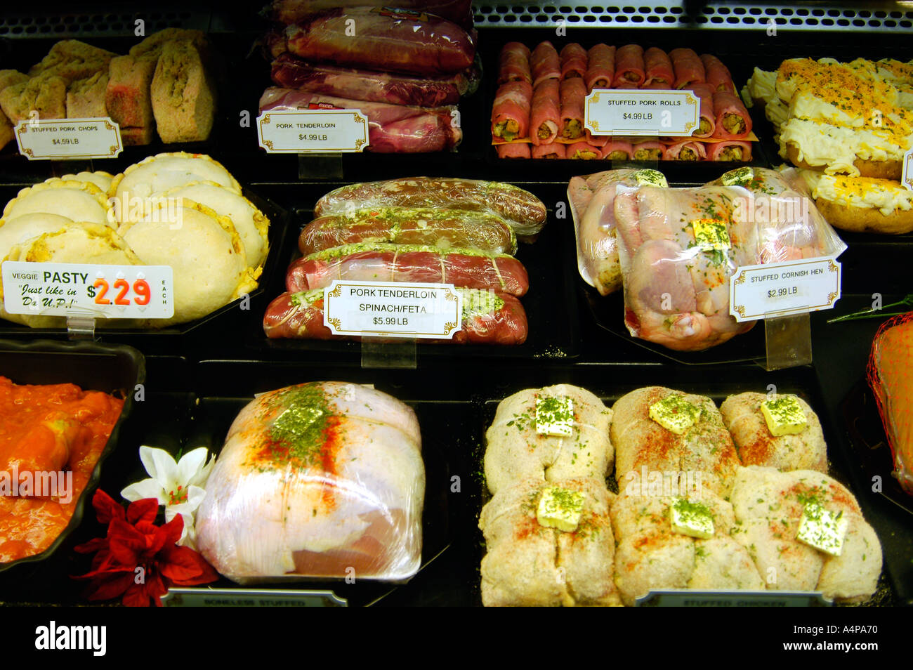 Fresh red meat fish vegetables fruit and poultry on display in a meat ...