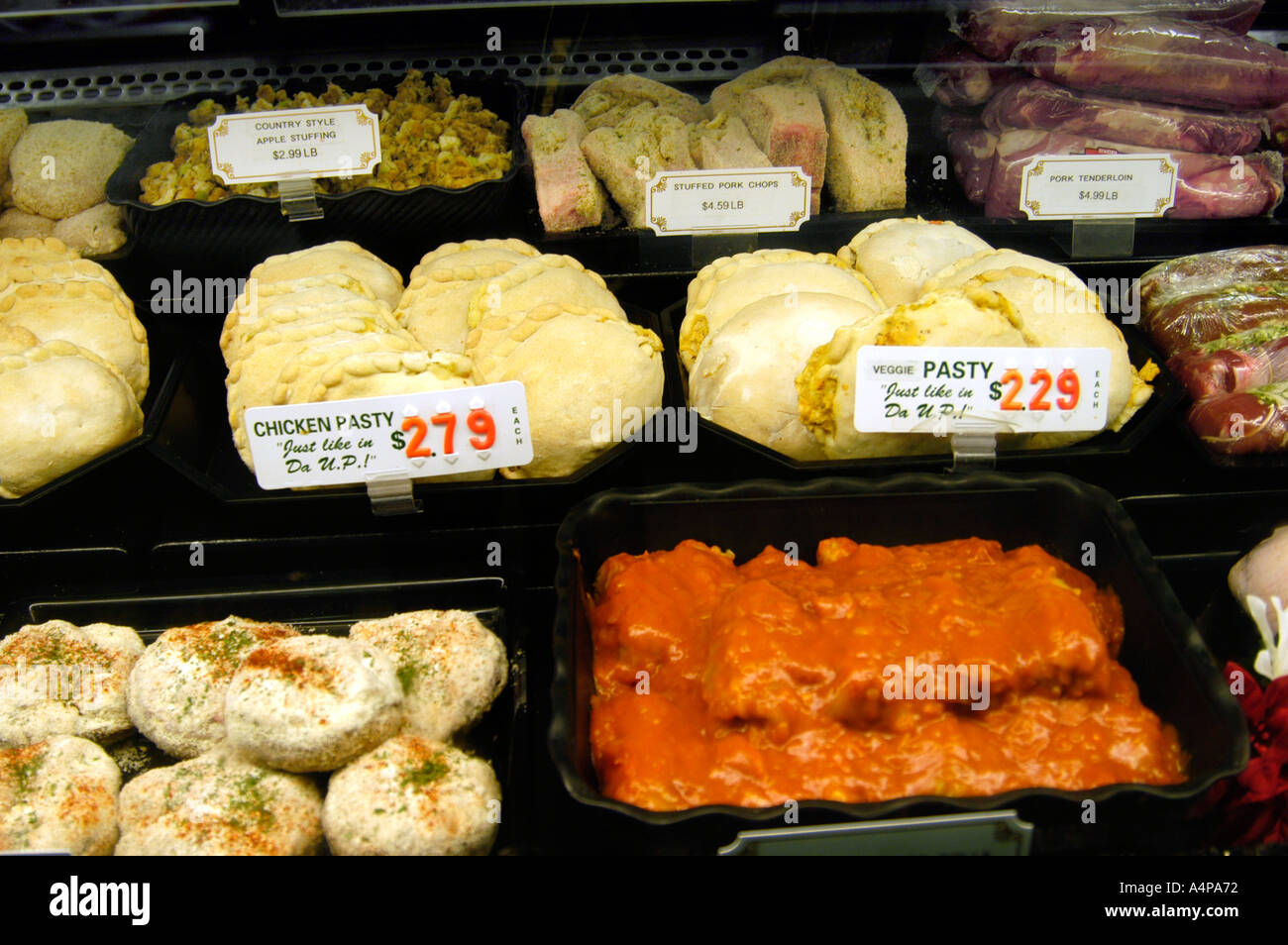 Fresh red meat fish vegetables fruit and poultry on display in a meat ...