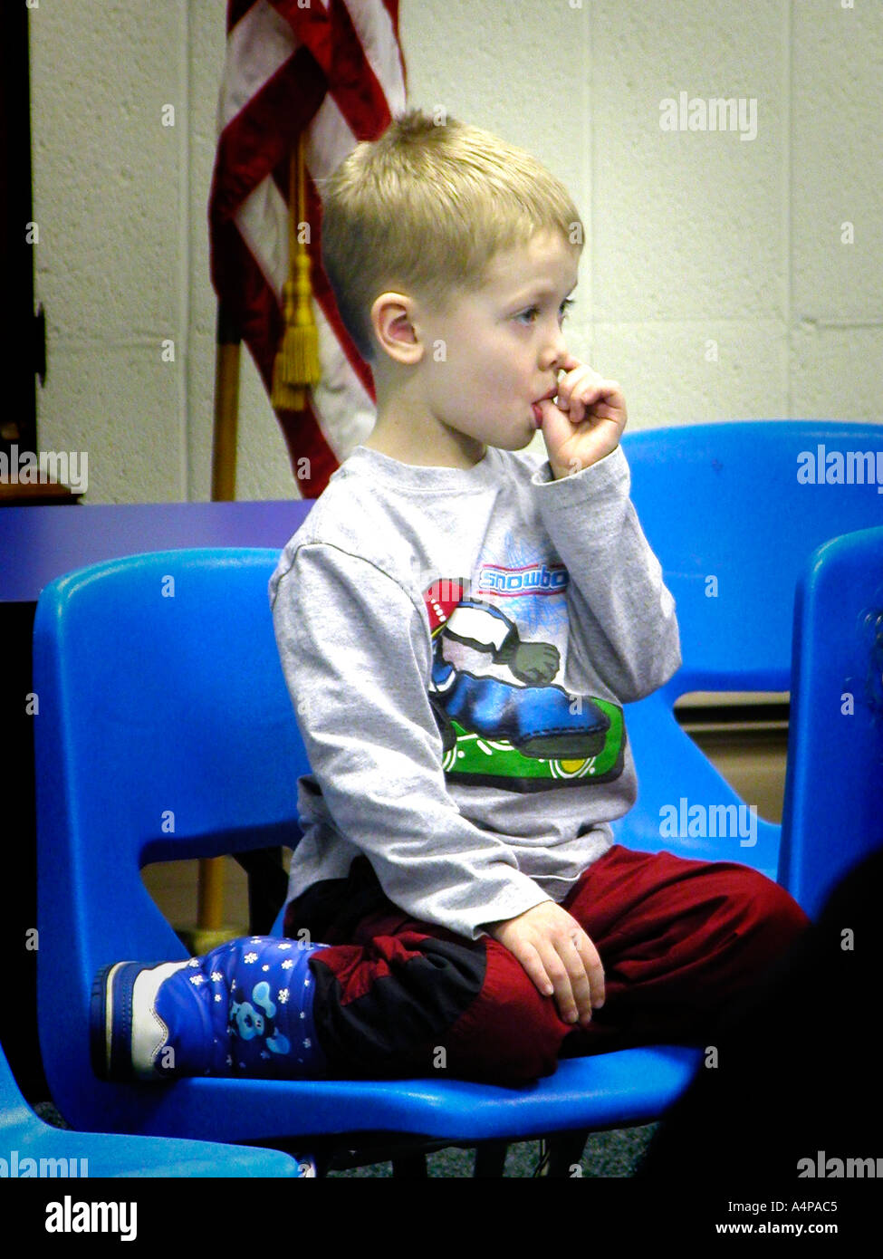 3 year old boy kneels on chair sucking thumb Stock Photo - Alamy