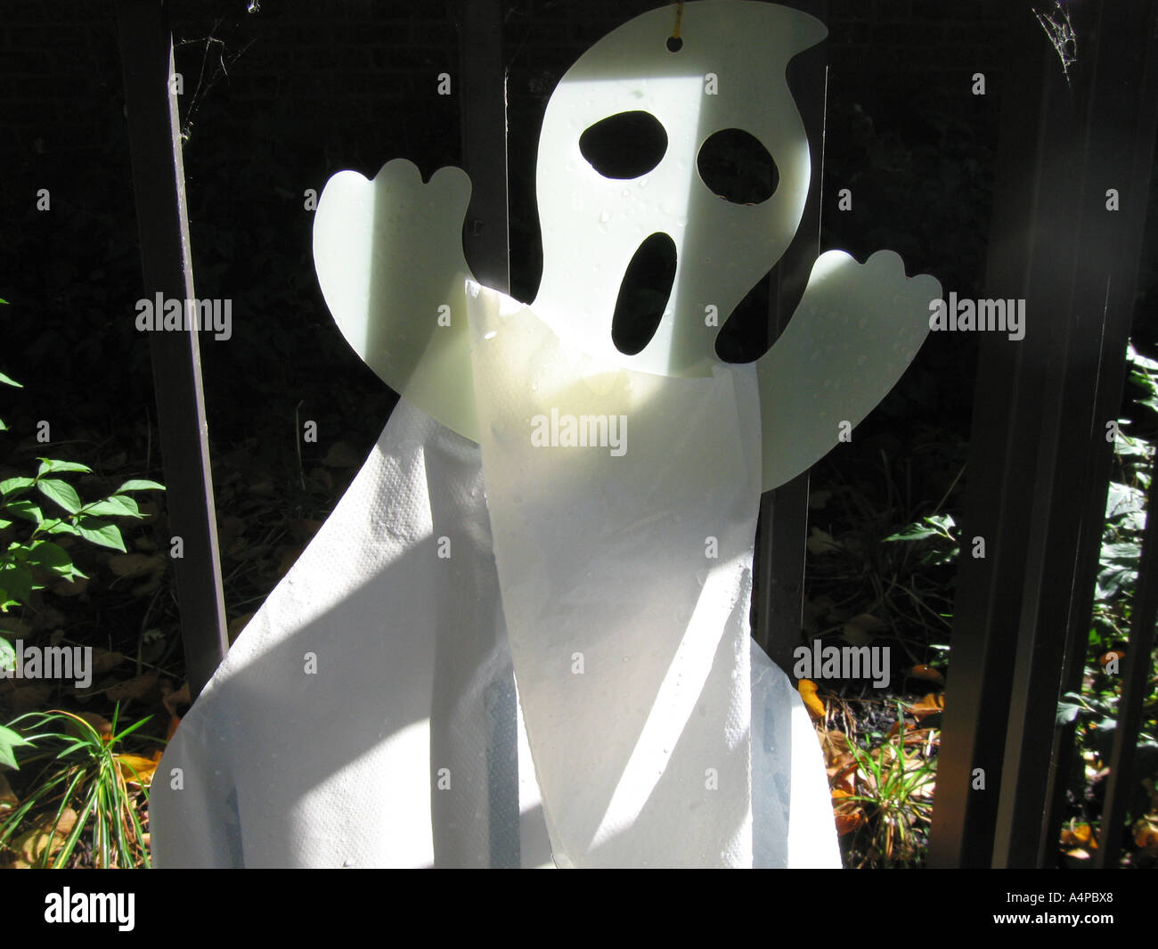 Ghost Halloween outdoor cutout on front fence Stock Photo - Alamy