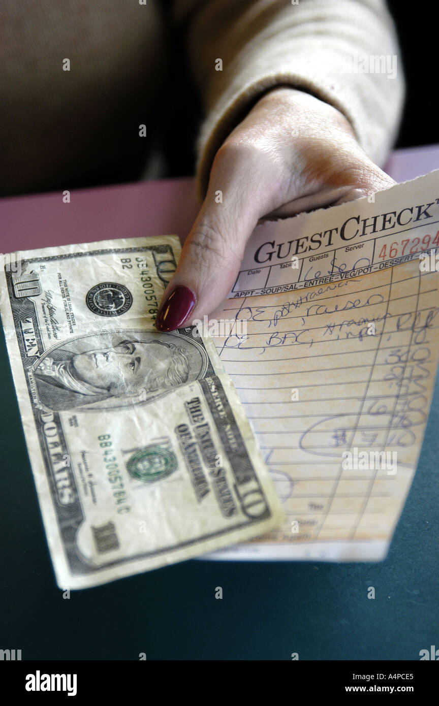 Hand holding guest check and money ready to pay bill Stock Photo - Alamy
