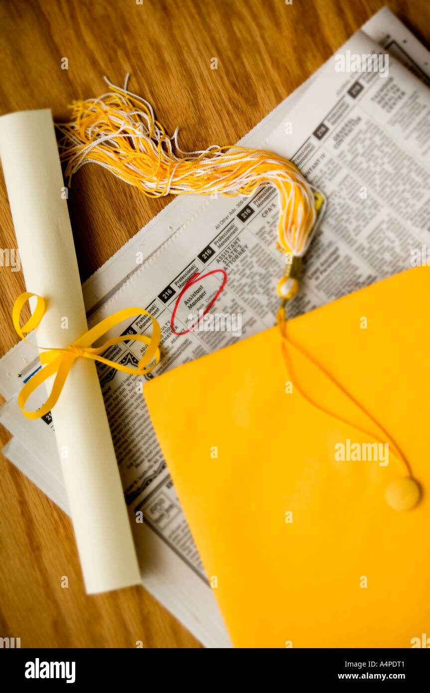 Graduation cap diploma and tassel setting on help wanted ads Stock ...