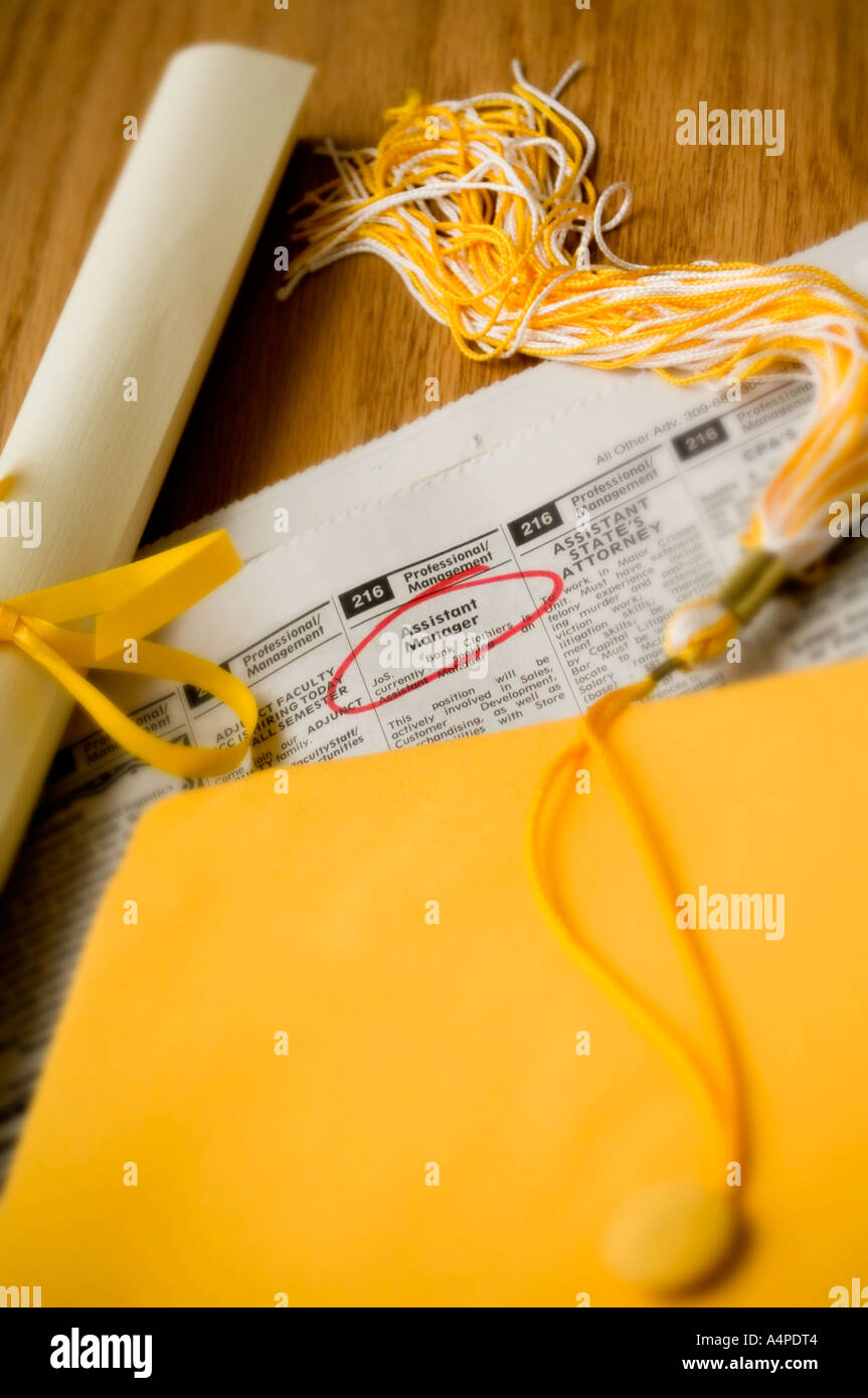 Graduation cap diploma and tassel setting on help wanted ads Stock ...