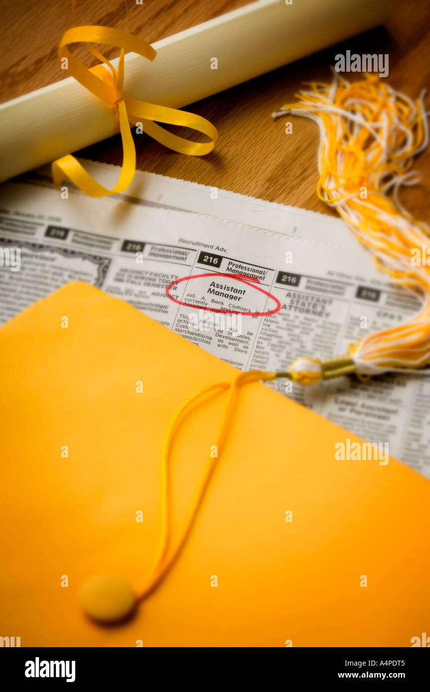 Graduation cap diploma and tassel setting on help wanted ads Stock ...