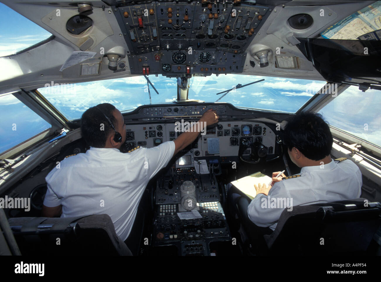 Pilot flying aircraft, rear view Stock Photo - Alamy
