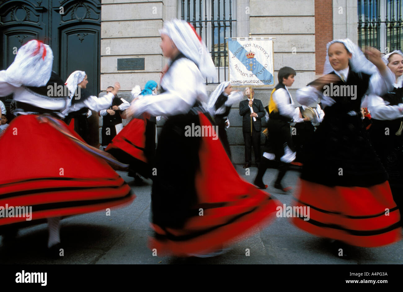 Spaniards in national dress performing outdoors at Plaza de la Puerto ...