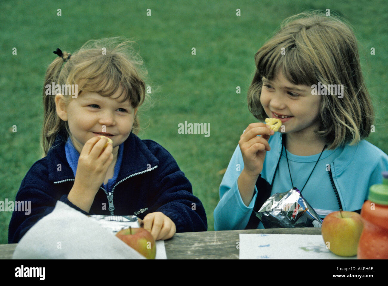 Two girls having snack hi-res stock photography and images - Alamy