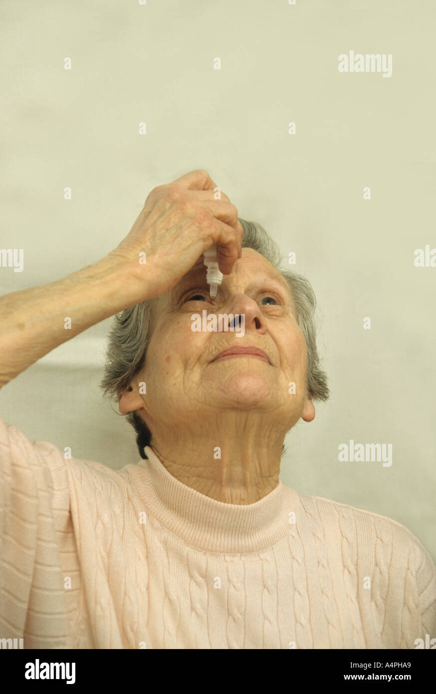elderly woman applying eye drops Stock Photo - Alamy