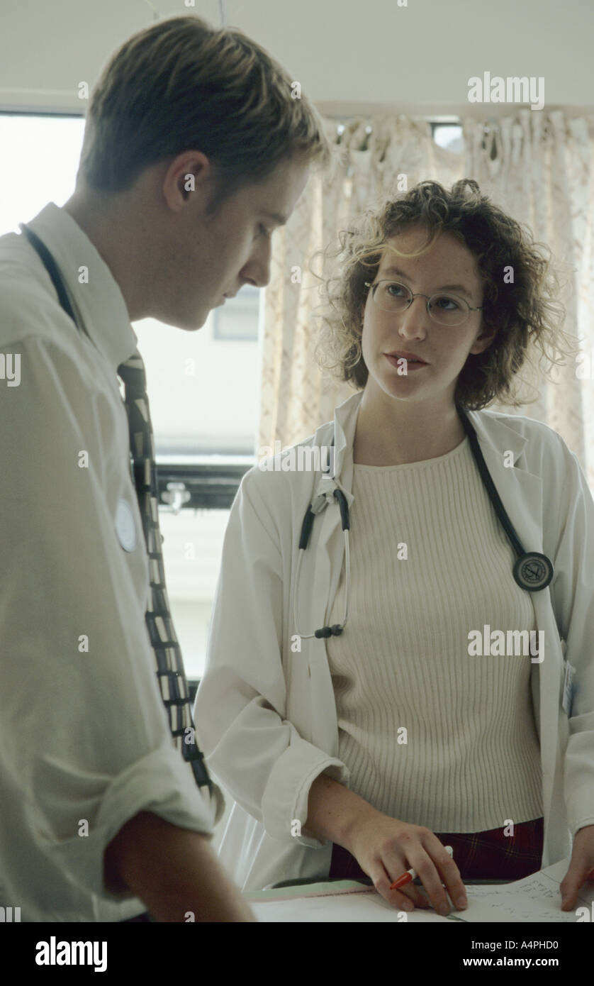 Male female doctors treating patients hi-res stock photography and ...