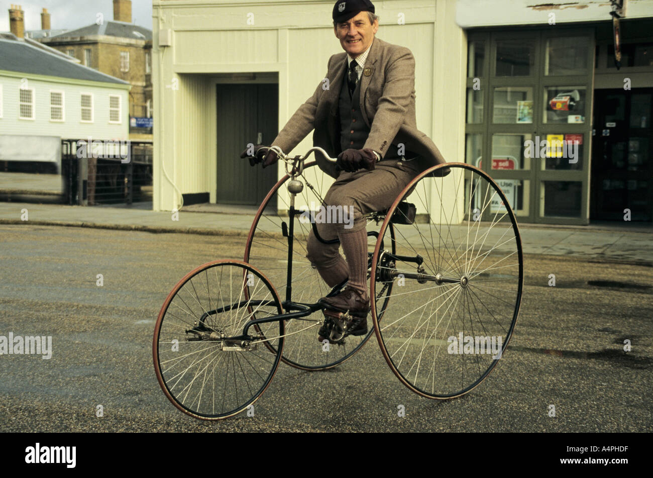 elderly gentleman riding an old fashioned bicycle re enactment ...
