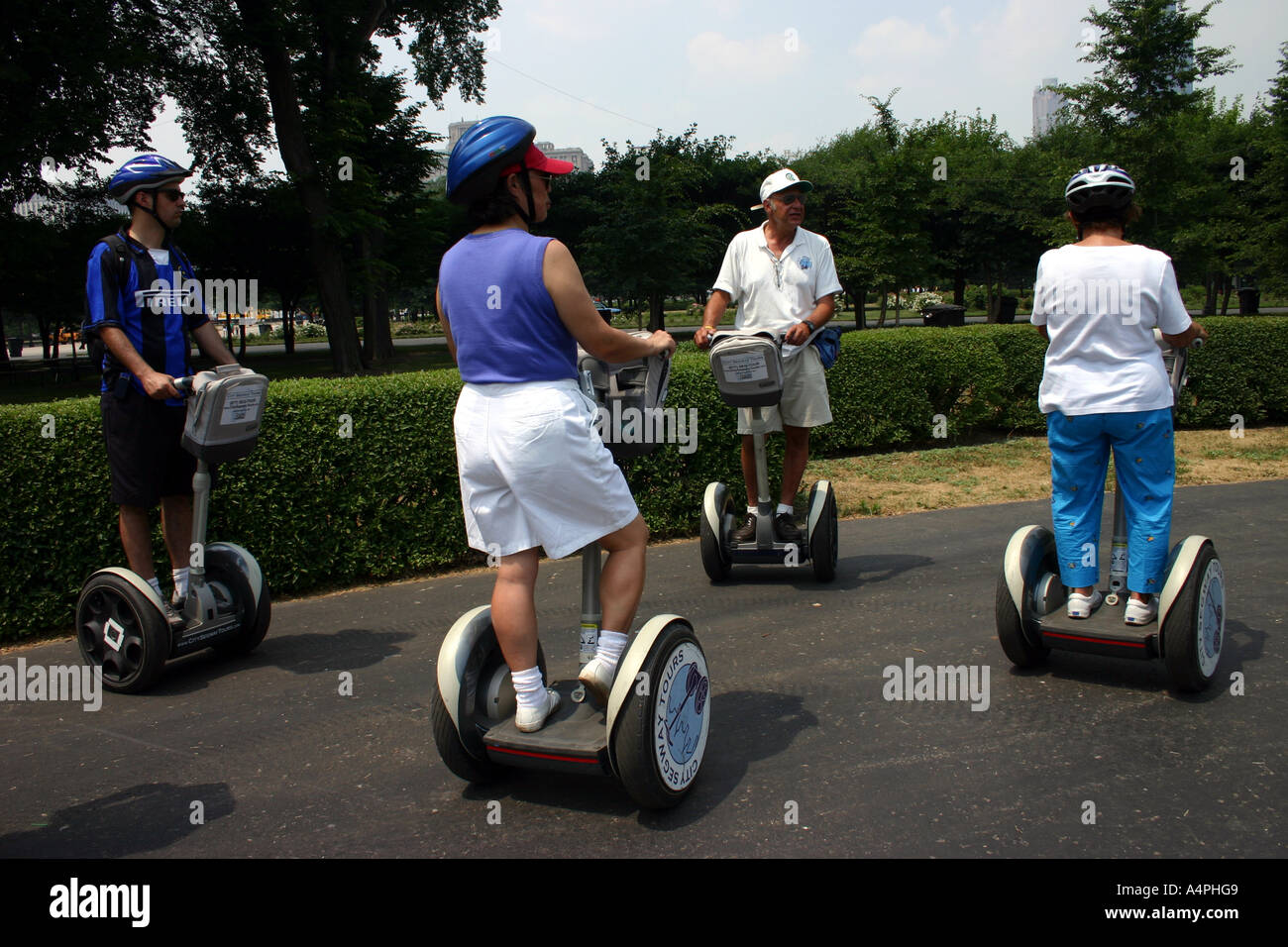 Man leading a tour of people riding Segway personal transporters ...