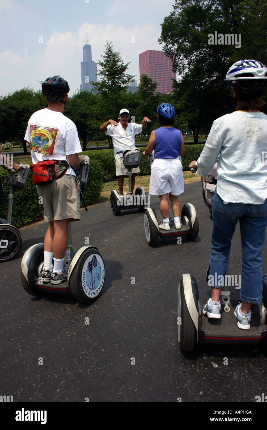 Man leading a tour of people riding Segway personal transporters ...