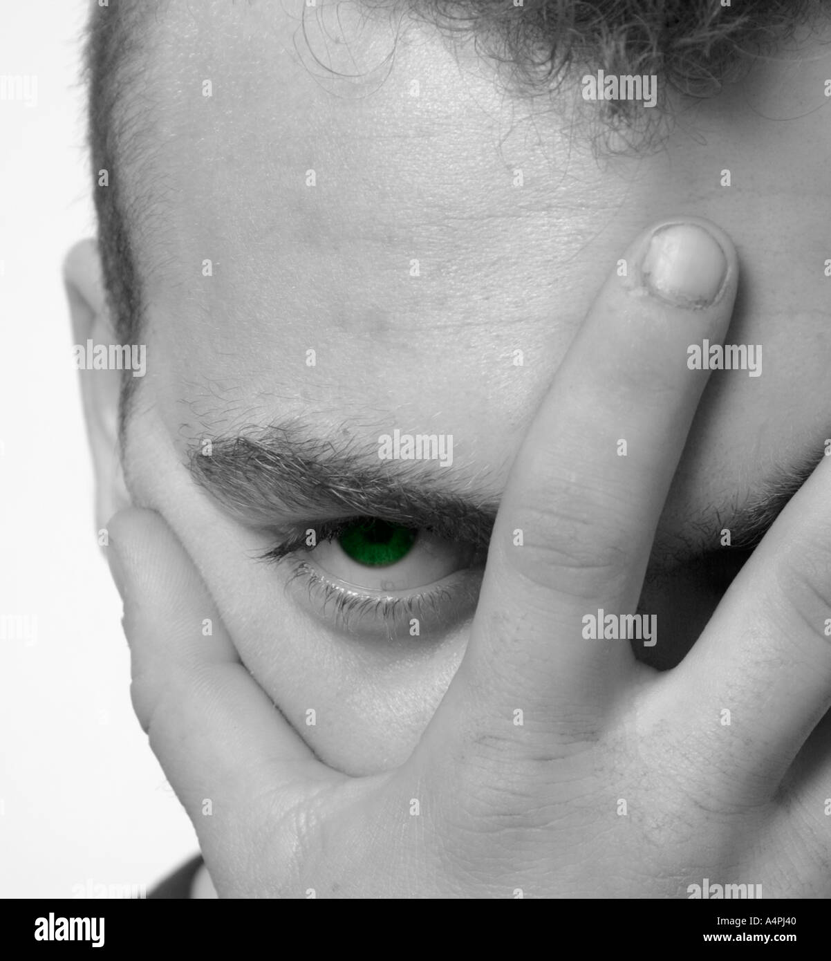 young man age between 20 and 25 hand over face shot in the studio on a ...