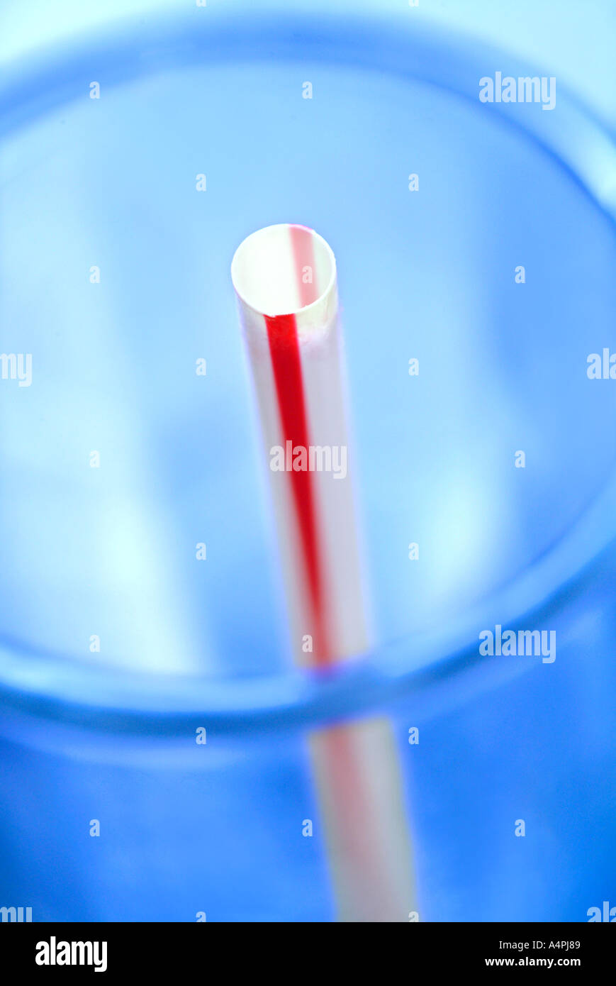 Straw sticking out of drinking glass Stock Photo - Alamy