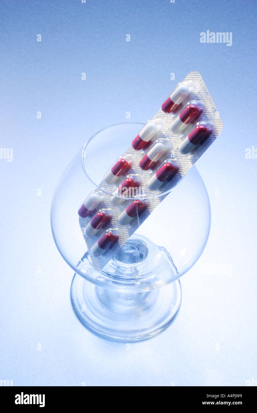 Capsules in Wine Glass Stock Photo - Alamy