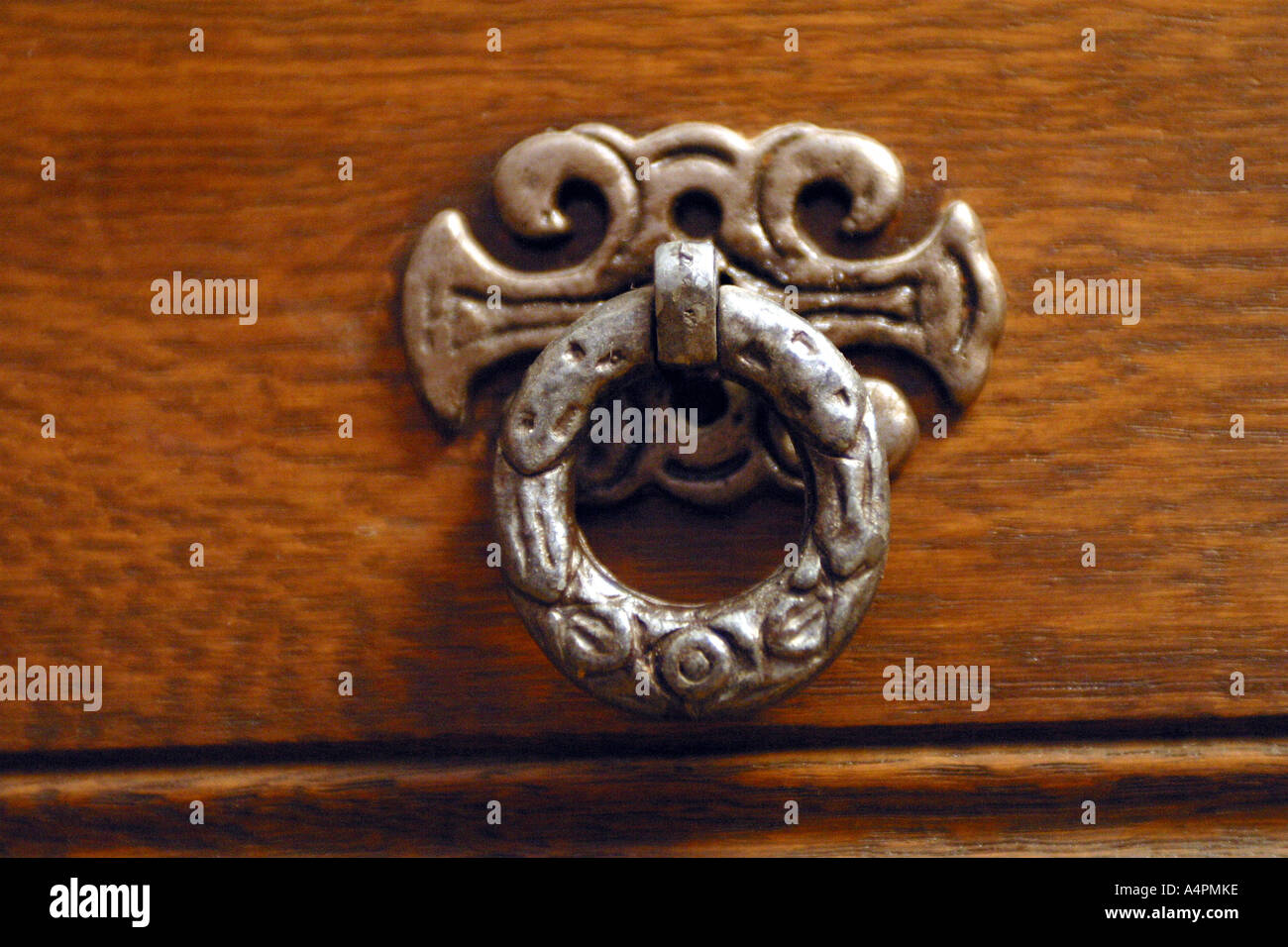 handcrafted engraved drawer handle on a piece of antique furniture ...